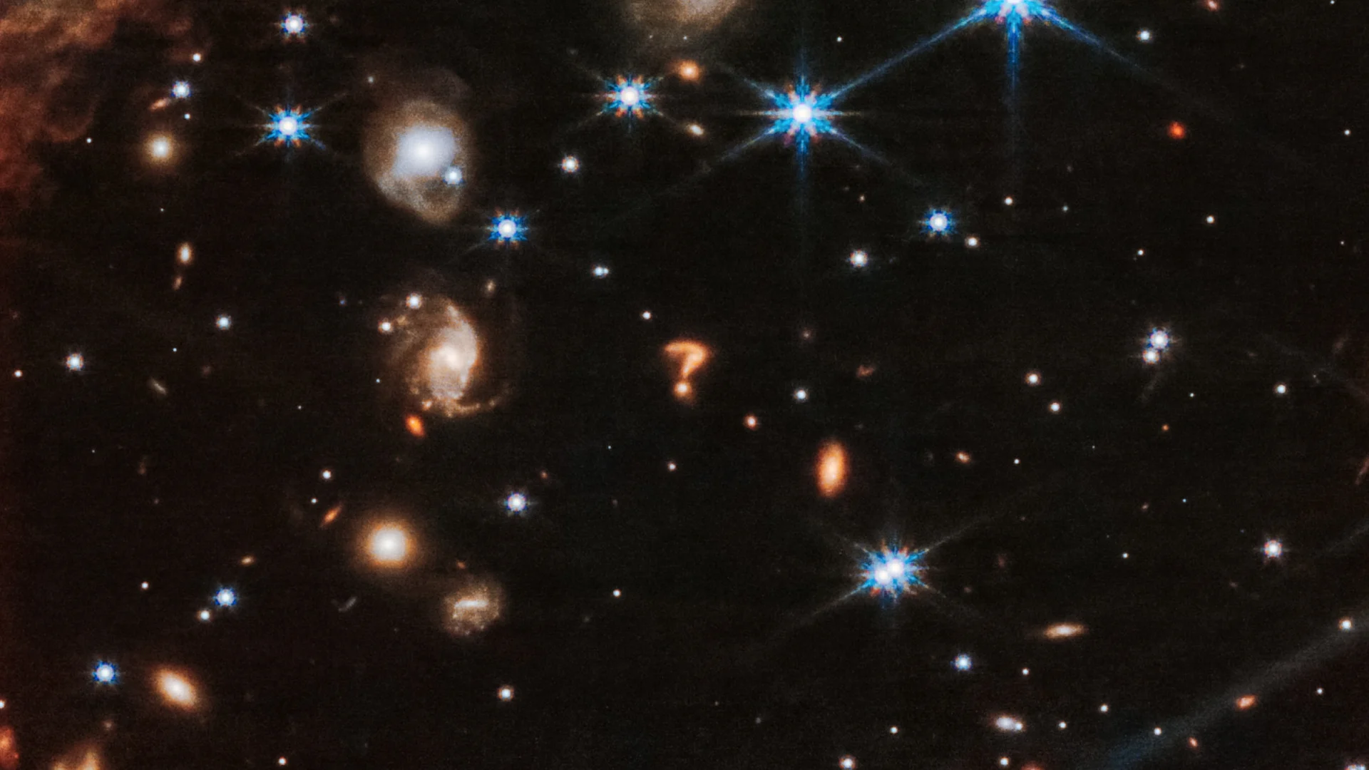 Webb spots a 'cosmic question mark' while peering at rambunctious young ...