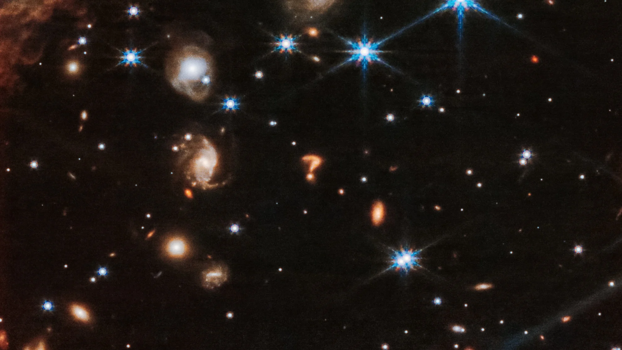Webb spots a 'cosmic question mark' while peering at rambunctious young ...